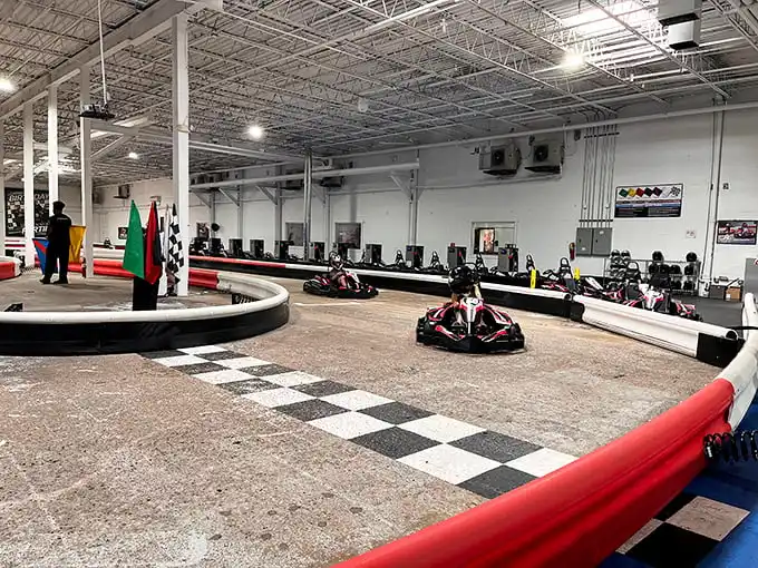 The checkered flag awaits as electric karts zoom around K1 Speed's professionally designed indoor track. Racing dreams come true regardless of weather outside.
