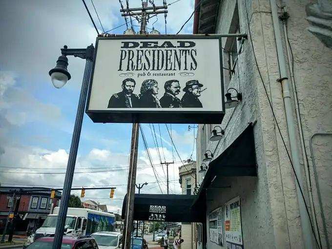 The iconic Dead Presidents sign welcomes patrons with silhouettes of Lincoln, Jefferson, Roosevelt, and Washington – history class never looked this appetizing.