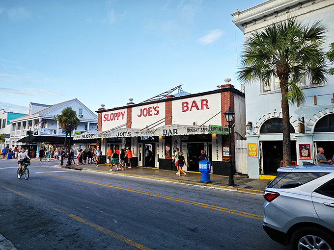 The iconic red and white façade of Sloppy Joe's stands proudly on Duval Street, beckoning visitors like a lighthouse for the thirsty sailor.