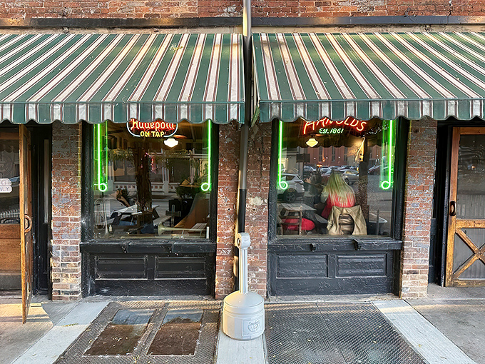 The unassuming exterior of Arnold's Bar & Grill beckons with its vintage charm and green-striped awning—Cincinnati's worst-kept secret hiding in plain sight.