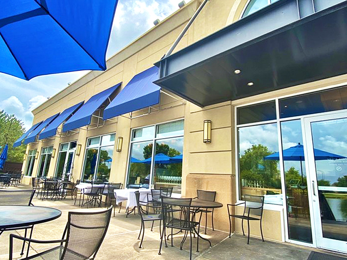Newport Grill's exterior welcomes you with cheerful blue umbrellas and a sunny patio—like the Mediterranean coast decided to vacation in Kansas.