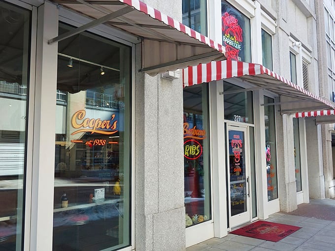 The neon glow of Clyde Cooper's storefront is like a lighthouse for hungry barbecue pilgrims, beckoning from downtown Raleigh since 1938. 
