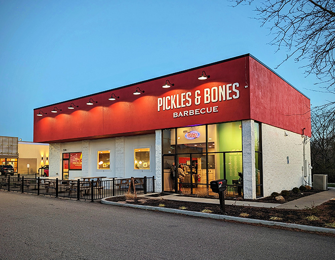 The bold red exterior of Pickles & Bones stands like a barbecue beacon in Milford, promising smoky treasures within those white-trimmed walls.