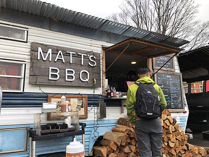The covered dining area at Matt's BBQ offers the perfect blend of Portland's outdoor vibe and Texas-style communal eating. Picnic tables await hungry patrons.