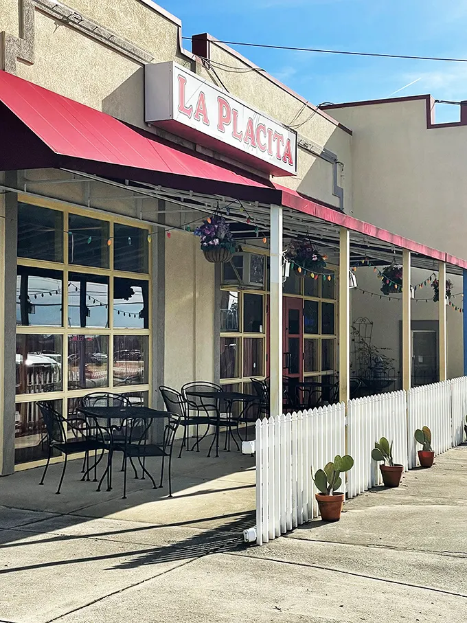 La Placita's cheerful exterior beckons with its bright yellow walls and red awning—like a sunset wrapped around a building that promises culinary adventure inside.