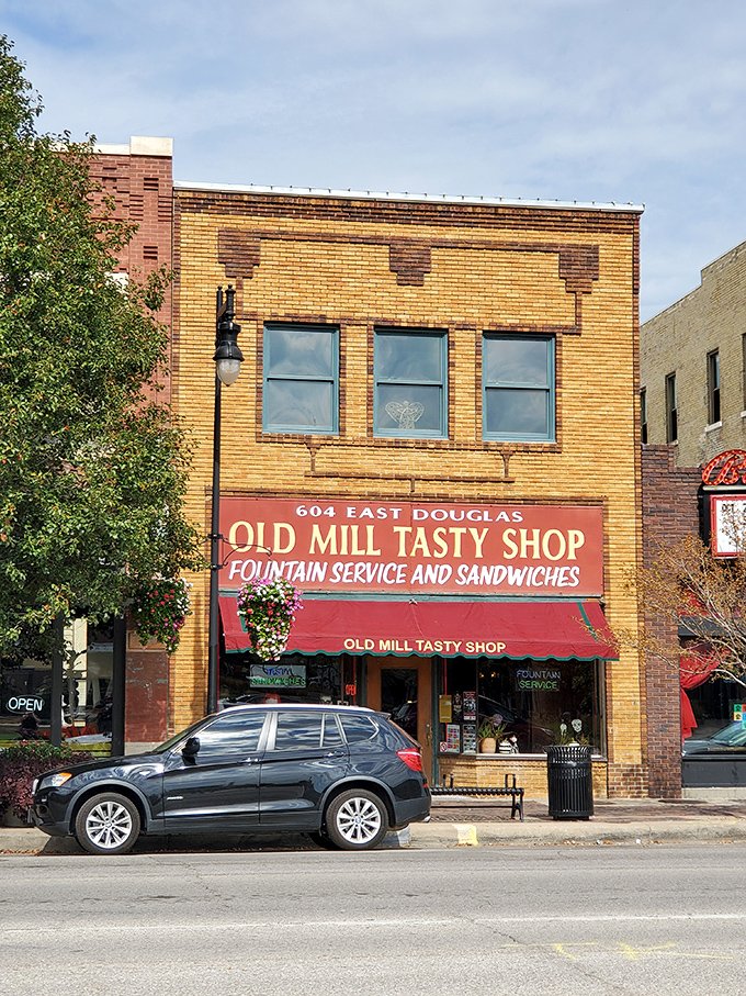 The Old Mill Tasty Shop's brick façade stands proudly on Douglas Avenue, a time capsule of Americana that's been satisfying Wichita's comfort food cravings for generations.