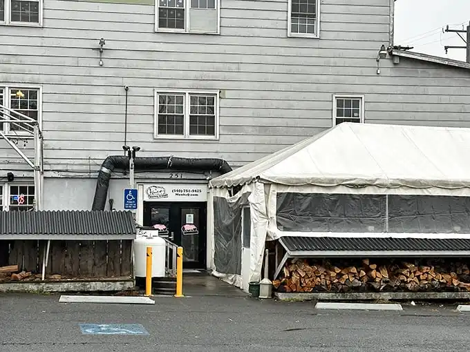 The white clapboard exterior of Monk's might seem unassuming, but those stacks of firewood tell you everything you need to know: smoke signals of deliciousness await inside.