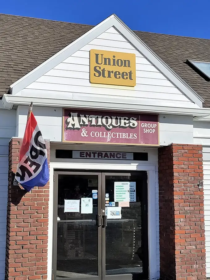The unassuming exterior of Union Street Antiques beckons with its yellow sign and classic New England charm—a time portal disguised as a simple white building.