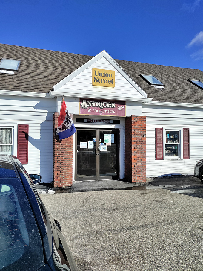 The unassuming exterior of Union Street Antiques beckons with its yellow sign and classic New England charm—a time portal disguised as a simple white building.