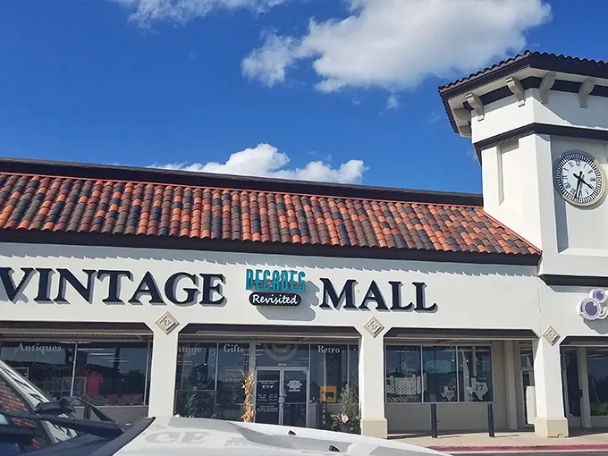 The Spanish-style facade with its signature clock tower offers zero hints about the time-traveling adventure waiting inside this unassuming Oklahoma strip mall.
