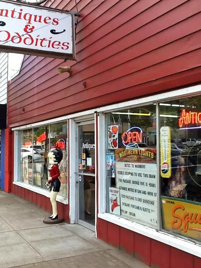 The wagon wheel above the storefront isn't just decoration—it's a time machine invitation to step back into a world where treasures await.