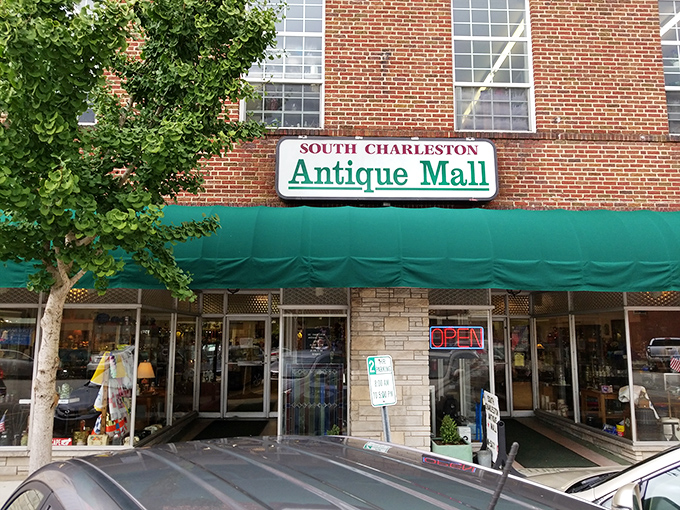 Where yesterday's treasures await tomorrow's collectors." The iconic brick facade of South Charleston Antique Mall beckons with promises of discoveries beyond the green awning. 