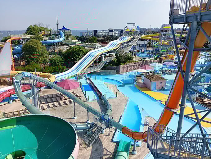 A rainbow of water slides cascades into crystal blue pools, promising the kind of summer day that makes winter worth enduring.