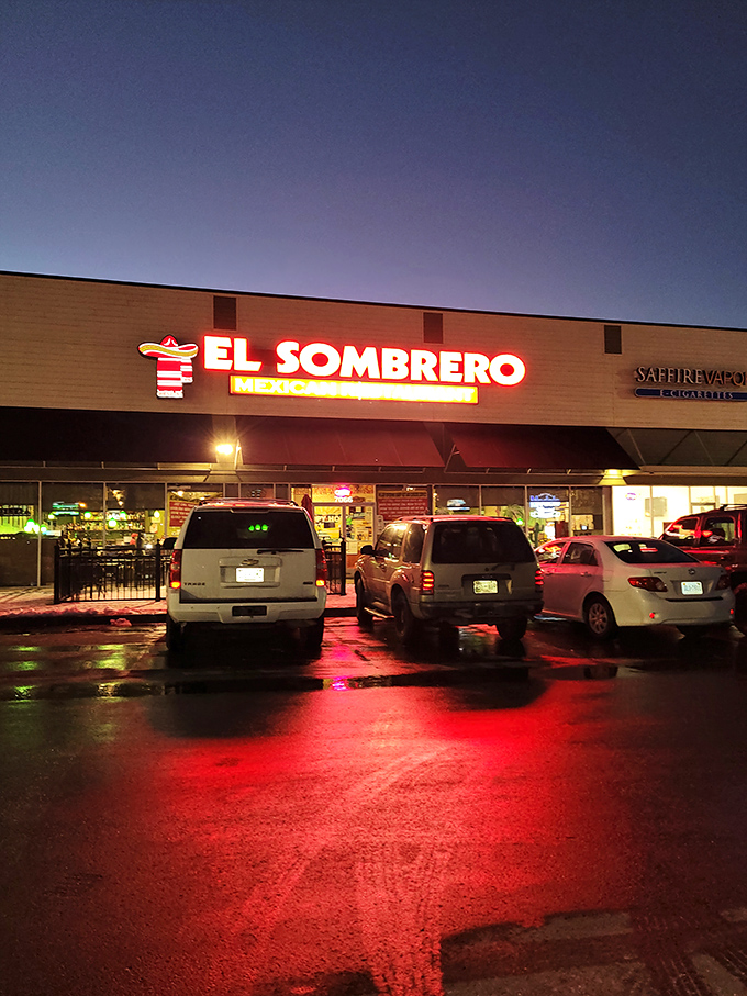 The unassuming brick exterior of El Sombrero belies the culinary treasures within. Red signage and a simple "OPEN" sign invite curious diners to discover Franklin's hidden Mexican gem.