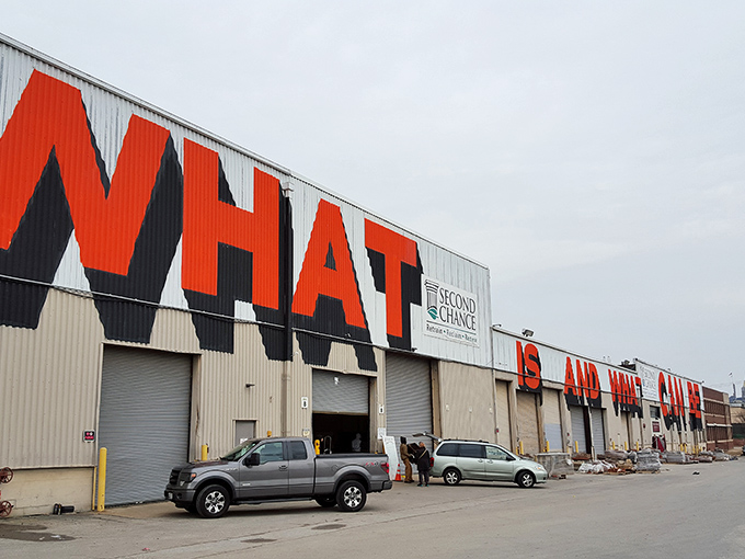 The giant "WHAT" emblazoned across this industrial facade isn't a question—it's the beginning of the treasure hunt that awaits inside Second Chance's massive warehouse.
