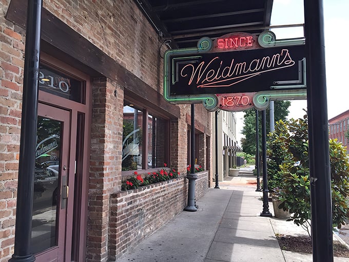 The iconic neon sign of Weidmann's glows like a beacon of culinary hope on a downtown Meridian street. Southern hospitality awaits just beyond those doors.
