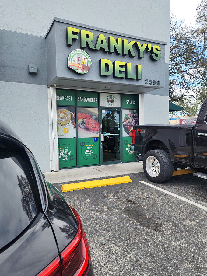 The unassuming storefront of Franky's Deli might not stop traffic, but the cars parked outside tell the real story—people come for the sandwiches, not the scenery.