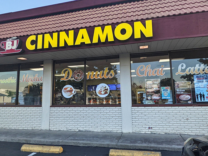 That bright yellow sign isn't just a beacon—it's a promise of pastry perfection waiting inside this unassuming Folsom strip mall gem.