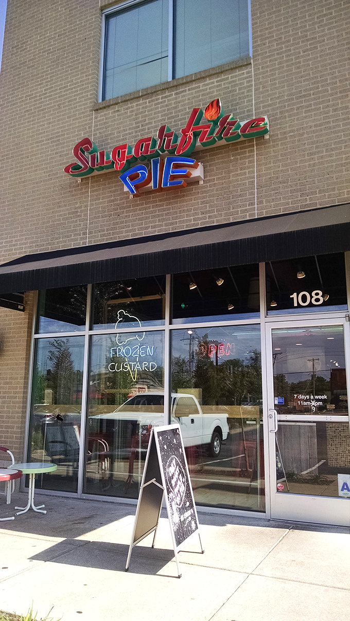 The colorful Sugarfire Pie sign promises "Custard Local Confections" – a beacon of sweetness in Olivette that delivers on every sugary syllable.