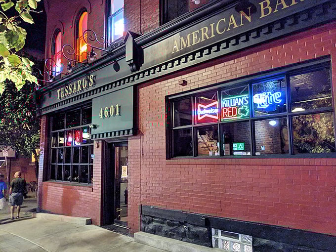 The brick facade of Tessaro's glows like a beacon for burger lovers, its neon signs promising cold beer and hot grills inside.