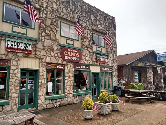 The stone facade of Hardy Sweet Shop stands like a sugar-dusted fortress, those cheery red awnings practically shouting "abandon diets, all ye who enter here!"
