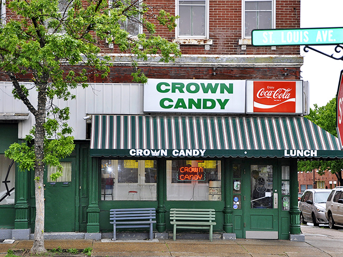 The green-and-white striped awning of Crown Candy Kitchen isn't just a canopy—it's a time machine to when soda jerks ruled and calories didn't count.