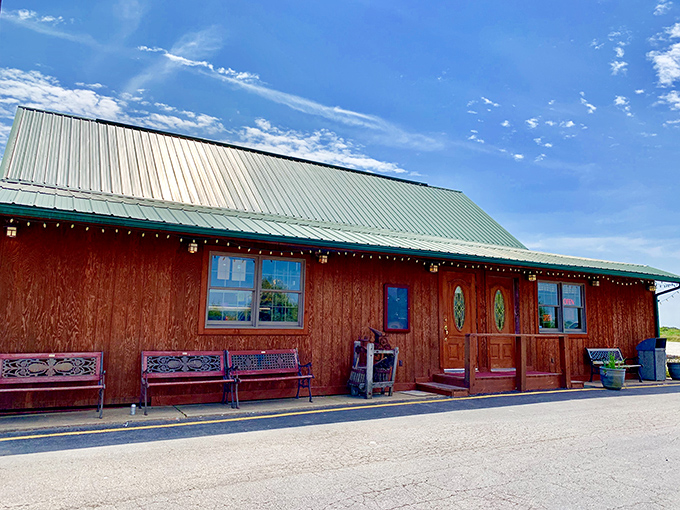 The red-stained timber exterior of Rustic Oak beckons like a carnivore's lighthouse in rural Missouri—rustic benches inviting you to sit a spell before the feast begins.