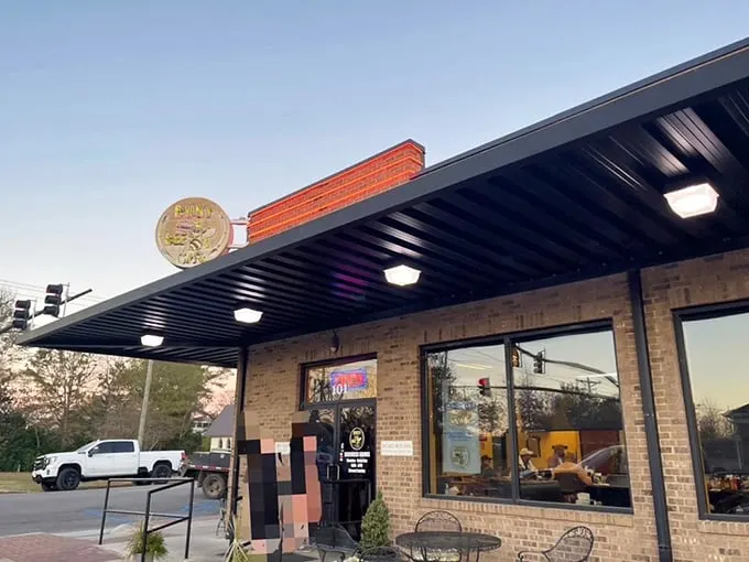 The humble brick exterior of Busy Bee Café stands like a beacon of breakfast hope, its cheerful yellow sign promising delicious revelations within.