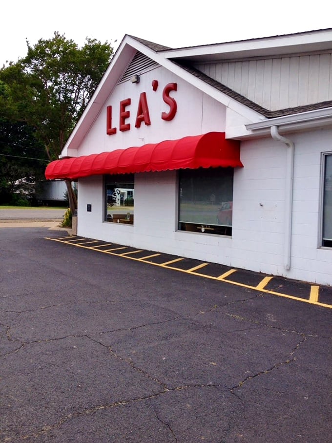 The iconic white building with bold red "LEA'S" lettering and matching awning stands as a beacon for hungry travelers – a Louisiana landmark since 1928.