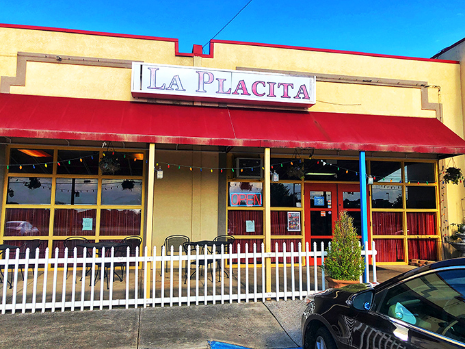La Placita's cheerful exterior beckons with its bright yellow walls and red awning—like a sunset wrapped around a building that promises culinary adventure inside.