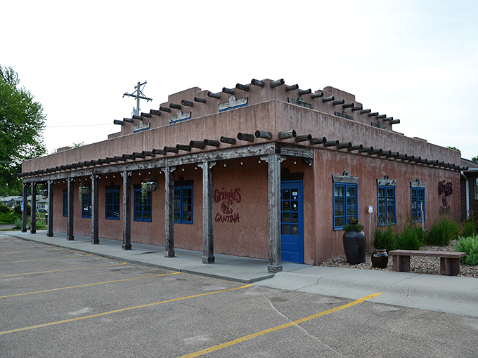Where New Mexico meets Nebraska: Gringo's adobe-style exterior with its distinctive vigas and bright blue doors is your first hint that culinary adventure awaits inside.