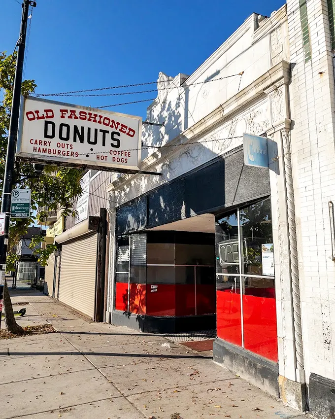 The unassuming white storefront with its vintage sign promises simple pleasures that fancy downtown bakeries can only dream of replicating.