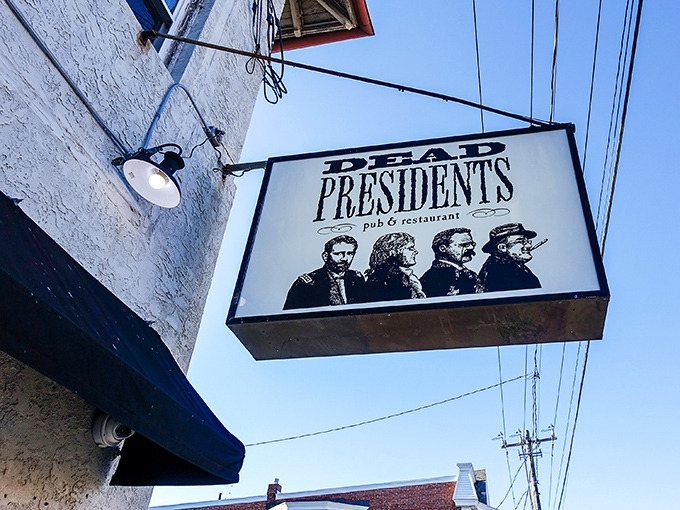 The iconic Dead Presidents sign welcomes patrons with silhouettes of Lincoln, Jefferson, Roosevelt, and Washington – history class never looked this appetizing.