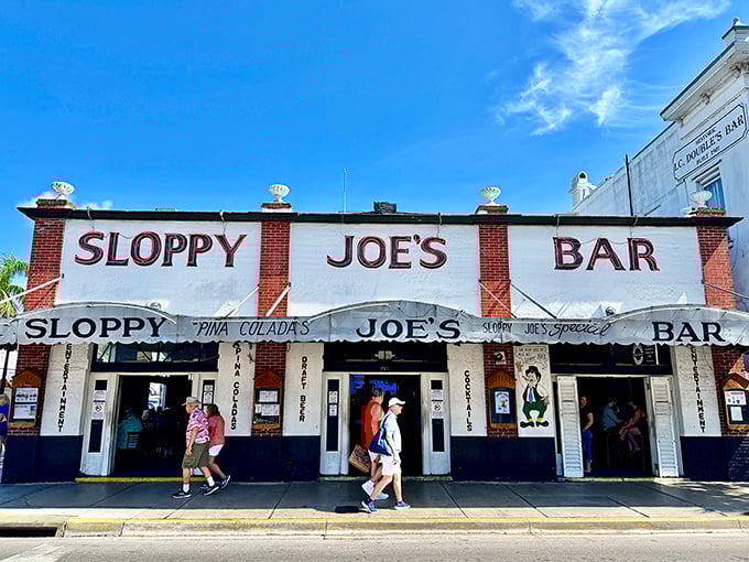 The iconic red and white façade of Sloppy Joe's stands proudly on Duval Street, beckoning visitors like a lighthouse for the thirsty sailor.