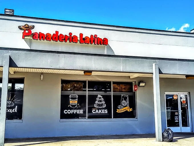 The bright red signage of Panaderia Latina beckons like a beacon of culinary promise. Coffee, cakes, and pastries await behind those unassuming doors.