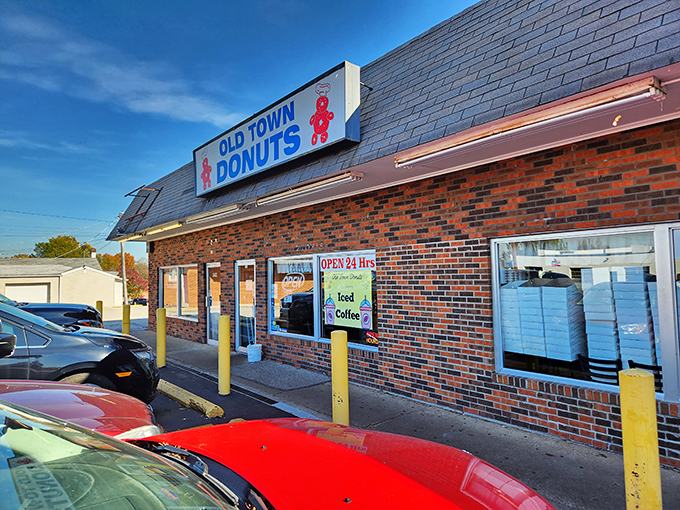 The iconic yellow hand holding a pink donut says it all – resistance is futile at this 24-hour temple of fried dough.
