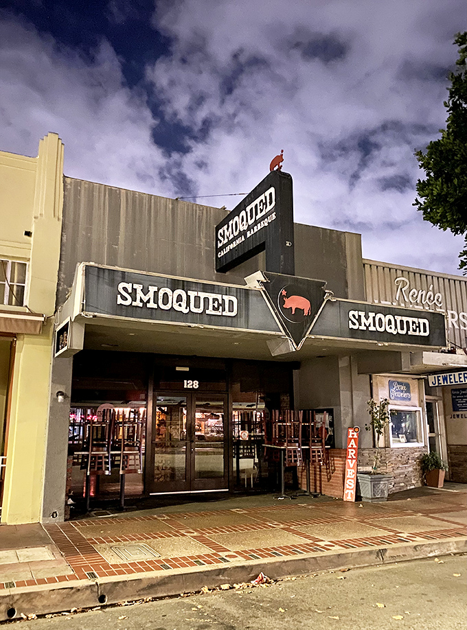 The pink pig silhouette perched atop Smoqued's sign isn't just cute – it's a beacon of hope for BBQ lovers wandering the California desert of mediocre meat.