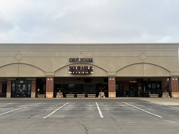 The unassuming retro sign of Six Mile Chop House beckons like a carnivore's lighthouse, promising safe harbor for the steak-obsessed traveler in Lawrence.