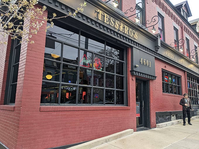 The brick facade of Tessaro's glows like a beacon for burger lovers, its neon signs promising cold beer and hot grills inside.
