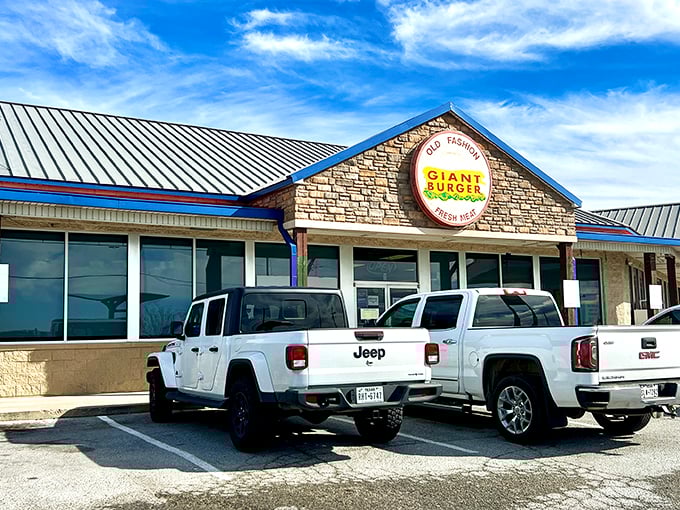 The stone facade and iconic circular sign promise what lies within: burger nirvana waiting just off the highway.