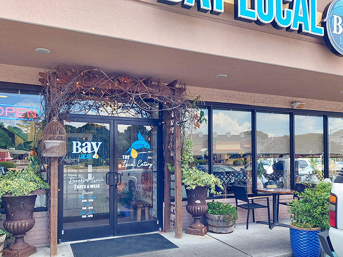 The coastal charm starts before you even step inside. Bay Local's entrance, adorned with lush greenery and rustic touches, promises a feast beyond the ordinary.