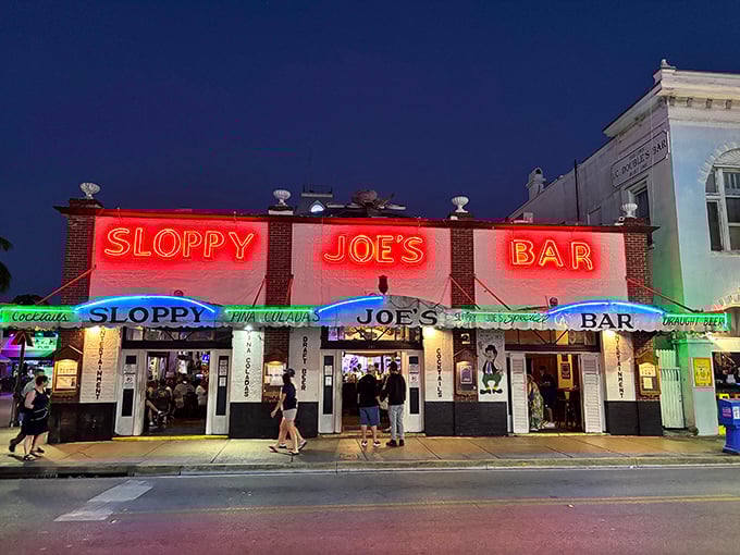 The iconic red and white façade of Sloppy Joe's stands proudly on Duval Street, beckoning visitors like a lighthouse for the thirsty sailor.