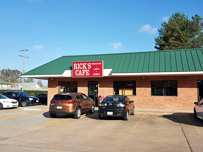 The unassuming brick exterior of Rick's Cafe stands like a culinary lighthouse, its green roof and straightforward signage promising honest food without pretense.