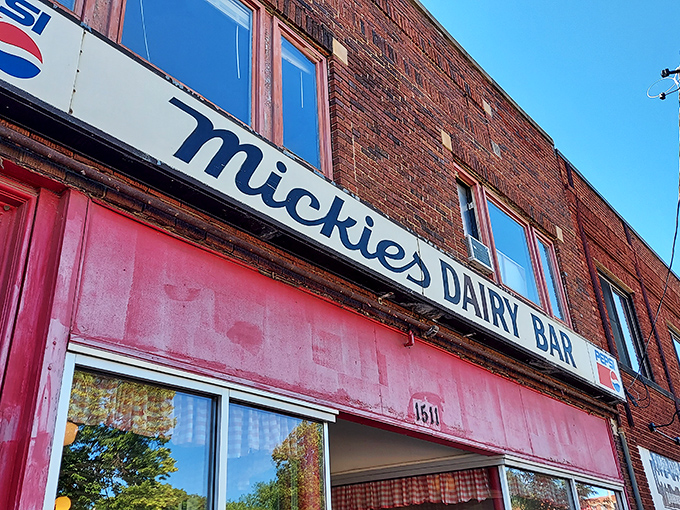 The iconic Mickies Dairy Bar sign stands proudly against Madison's skyline, a beacon of breakfast hope for hungry Badger fans and locals alike.