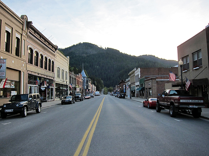 Wallace's historic downtown looks like a film set waiting for action—brick buildings standing proudly against a backdrop of evergreen-covered mountains.