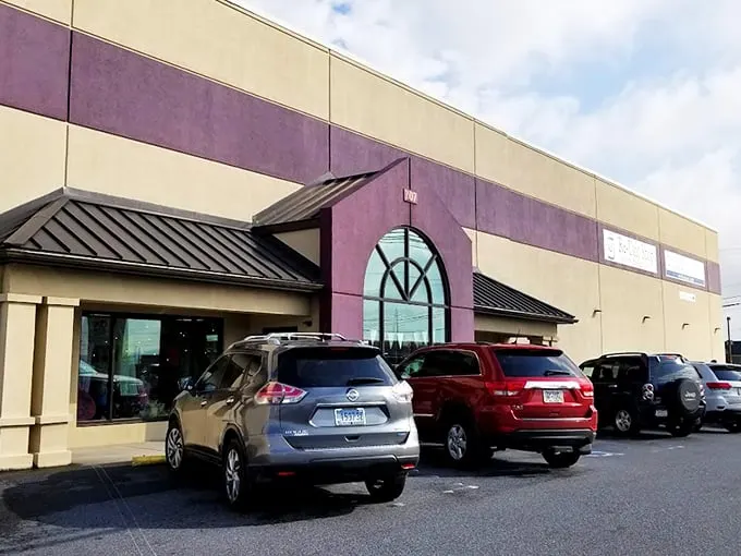 The distinctive purple and beige exterior welcomes treasure hunters with its arched window—like a portal to another shopping dimension.