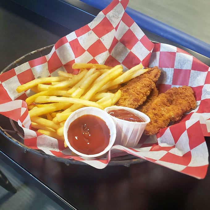 Chicken strips and fries served in checkered paper—because racing royalty deserves a throne-worthy meal between victory laps.