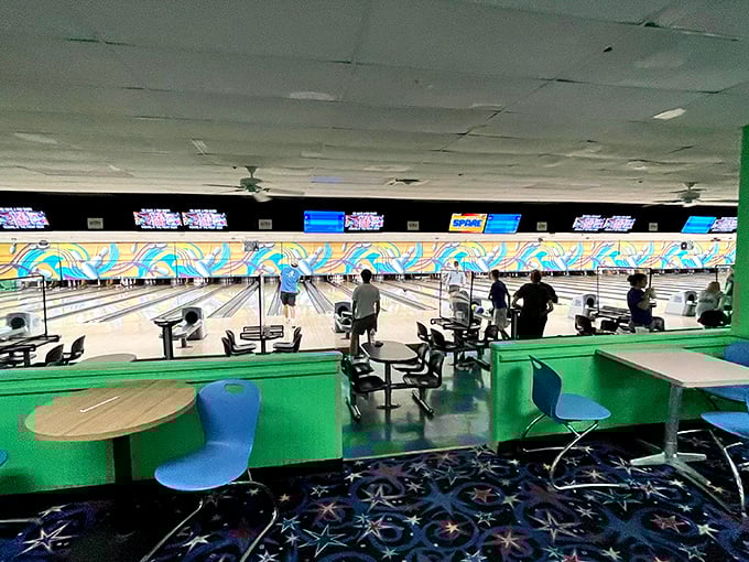 The tiered seating area offers the perfect vantage point to cheer on friends or strategize your approach to conquering that stubborn 7-10 split.