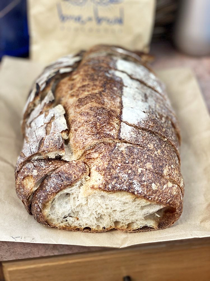 This sourdough doesn't just have a crust—it has character, with a crackling exterior that sings when squeezed like nature's bubble wrap.
