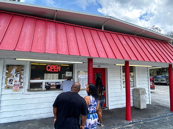 The universal language of anticipation—people from all walks of life united by the promise of perfectly fried deliciousness.